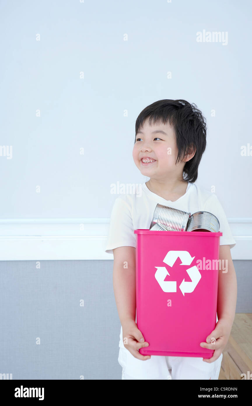 A boy holding a recycle bin Stock Photo - Alamy