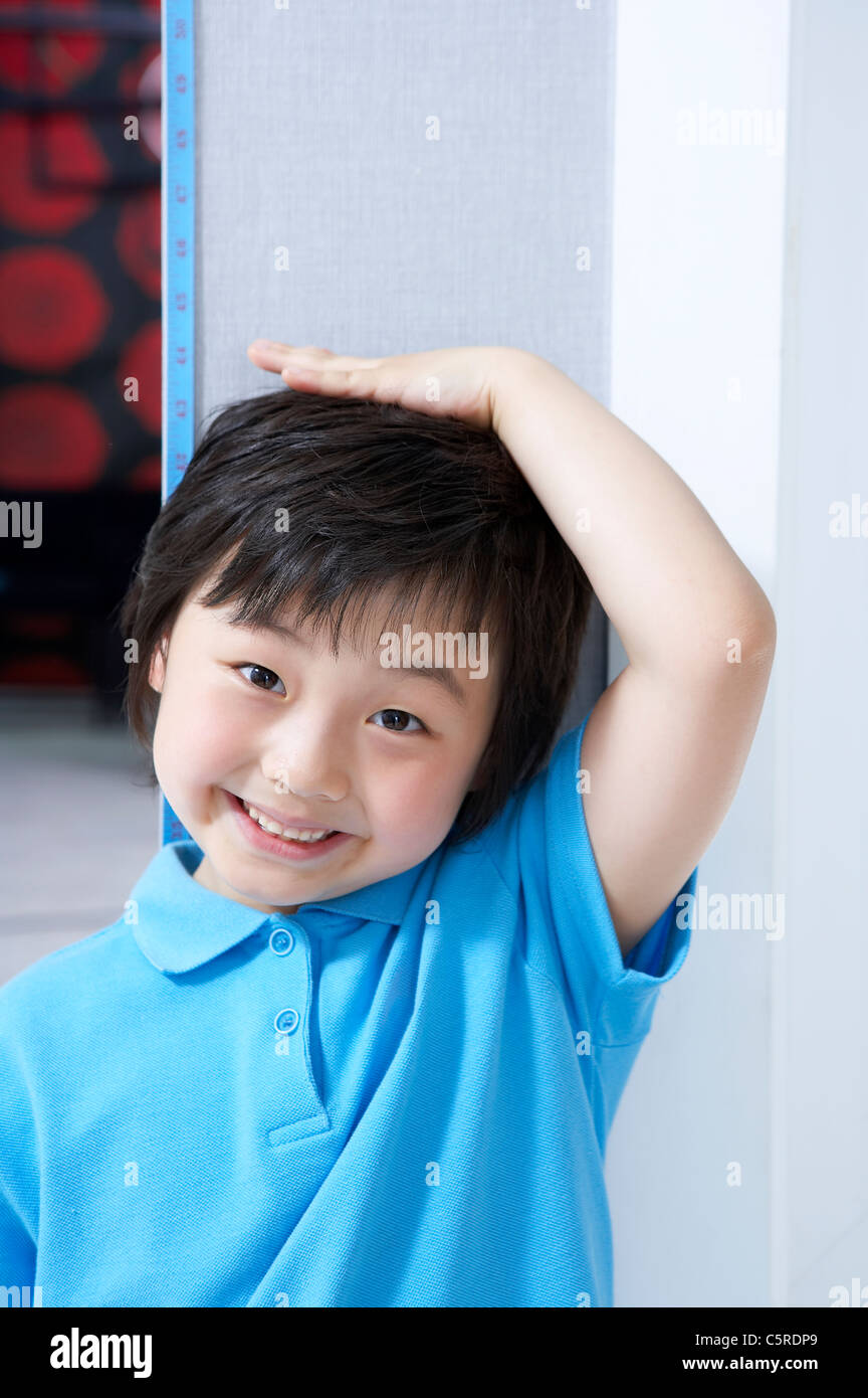 A boy measuring his height Stock Photo - Alamy