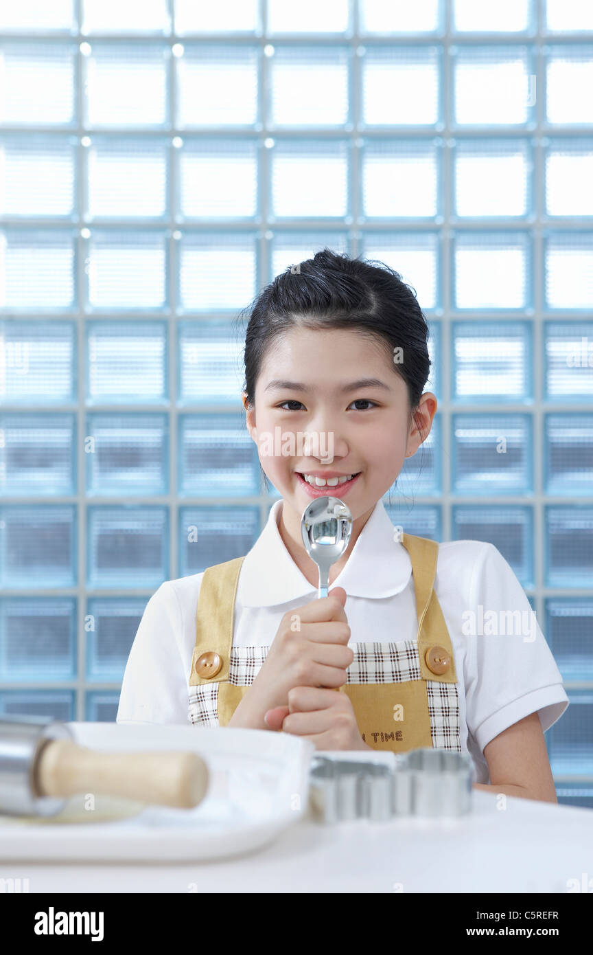 A girl smiling wearing apron Stock Photo - Alamy