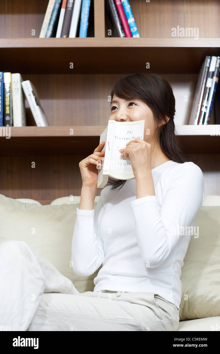 A woman reading a book Stock Photo - Alamy
