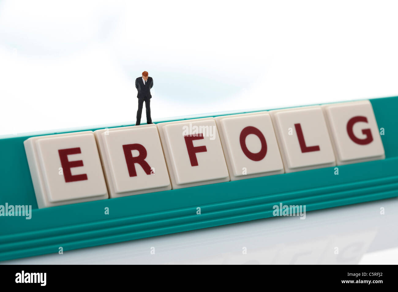 Business man figurine, Scrabble tiles forming the single word success ...