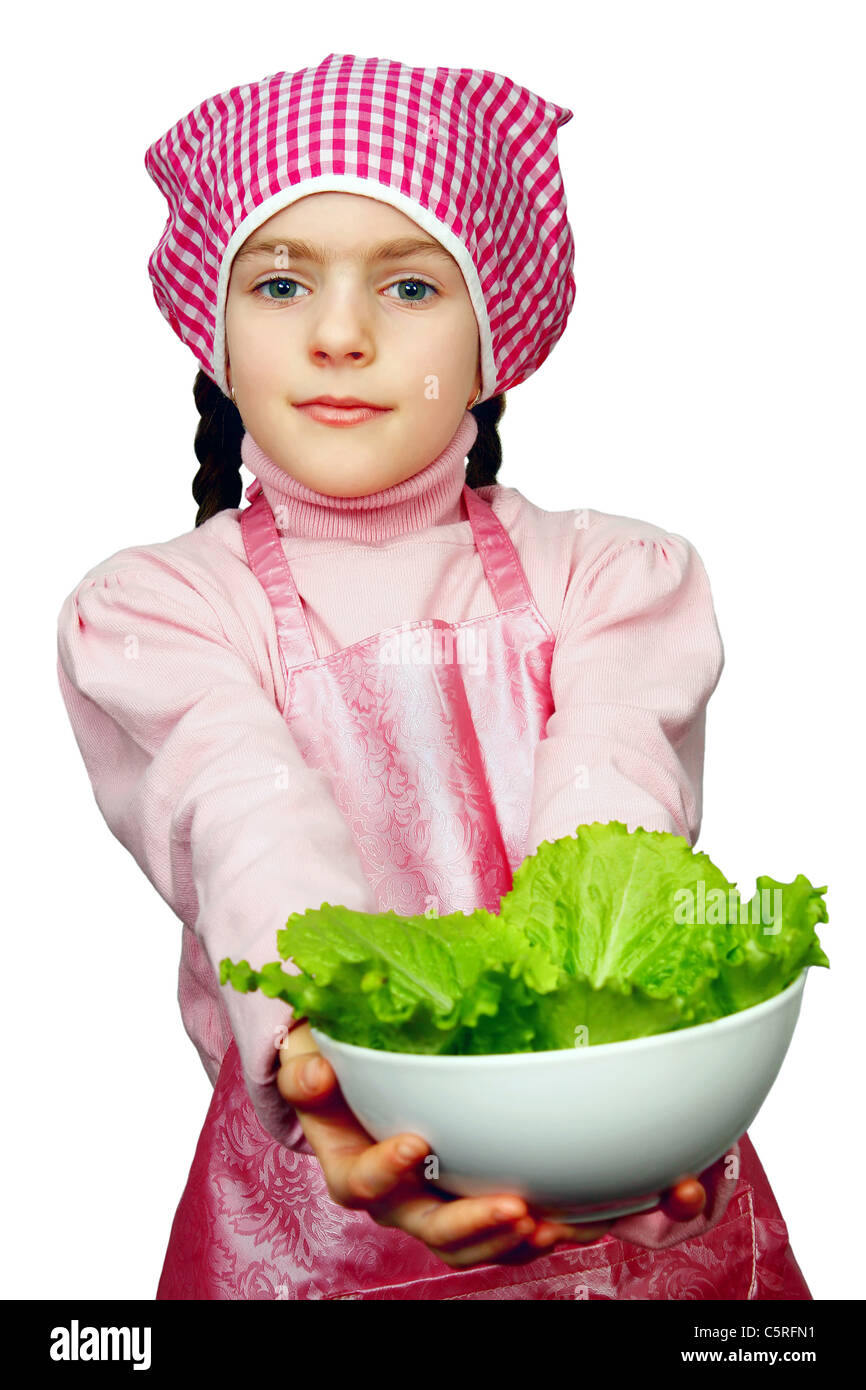 girl in an apron with the dish of lettuce isolated on white background ...