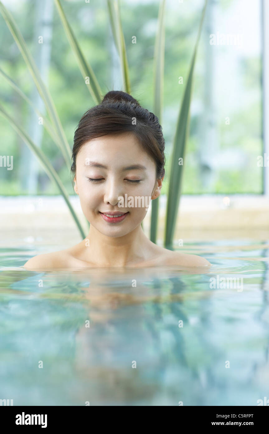 A woman inside water closing eyes Stock Photo - Alamy