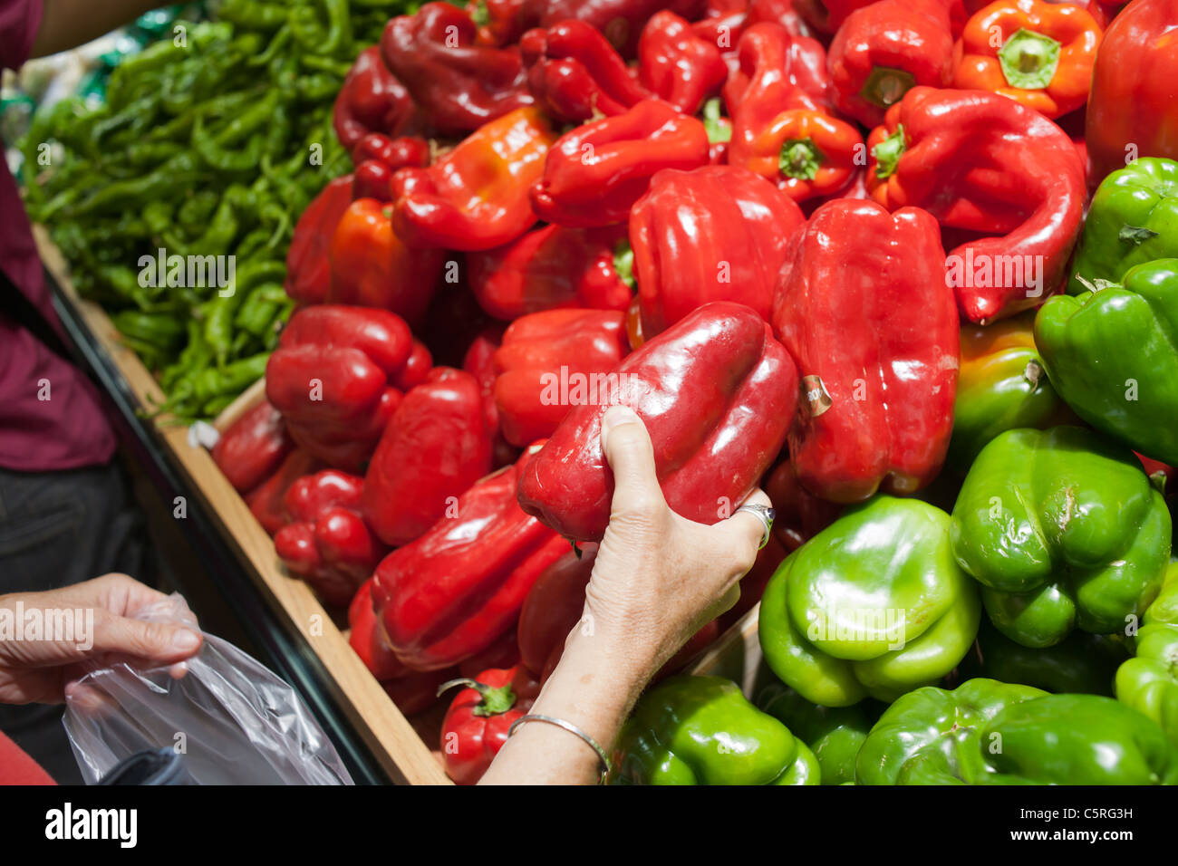 A shopper picks a pepper at the new Sky Foods supermarket in the Sky ...