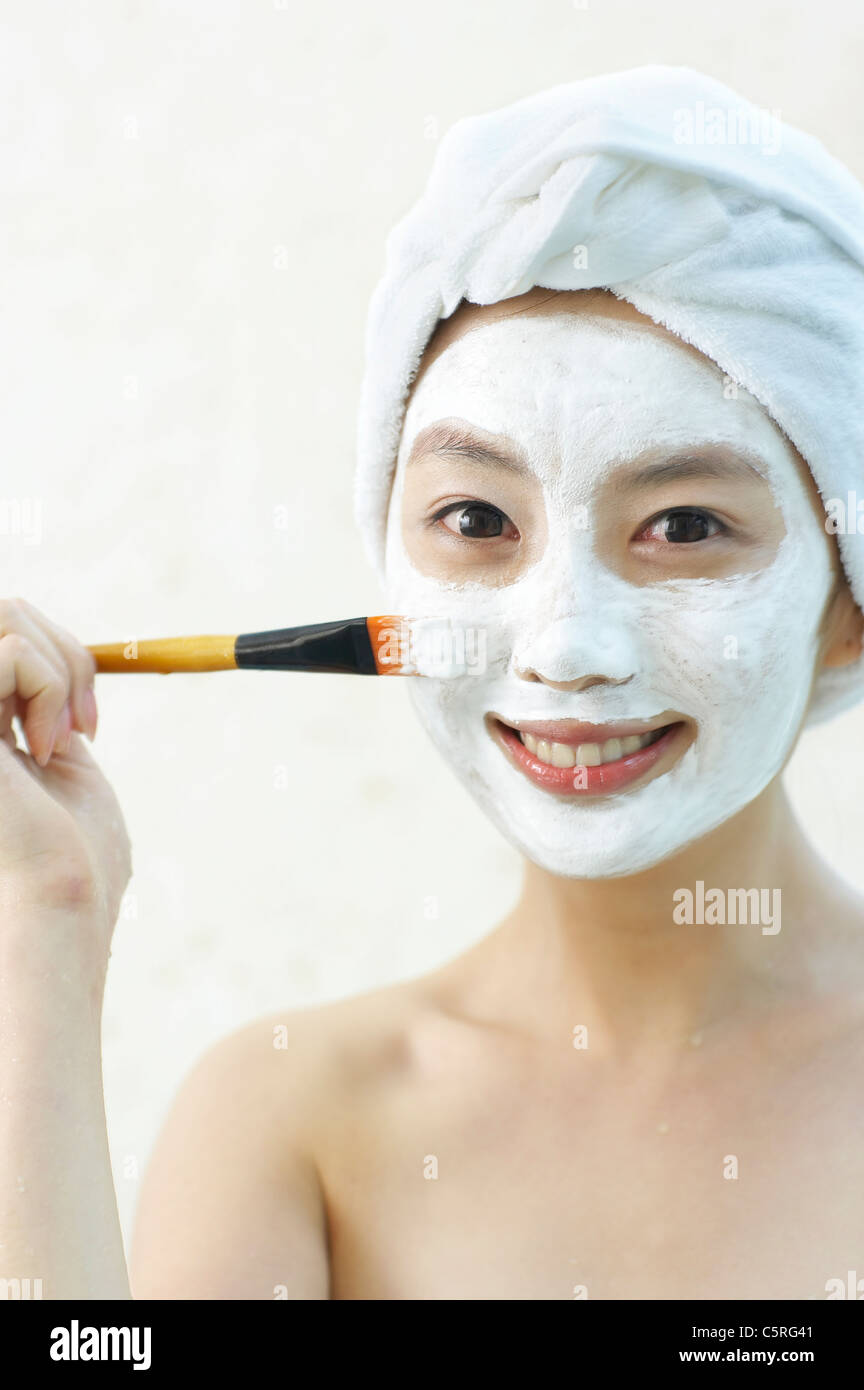 A woman applying facial pack Stock Photo - Alamy