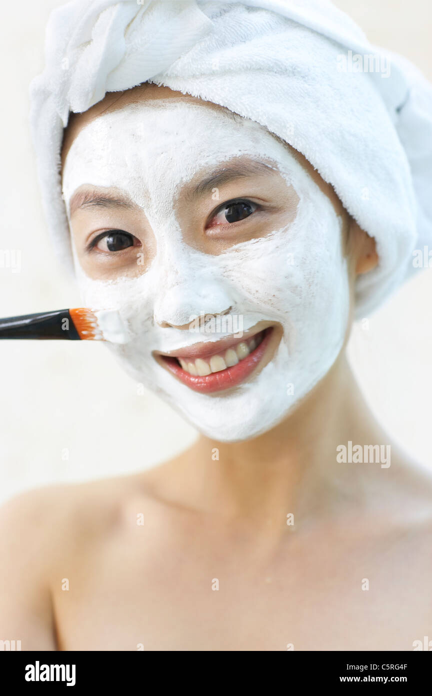 A woman applying facial pack Stock Photo - Alamy
