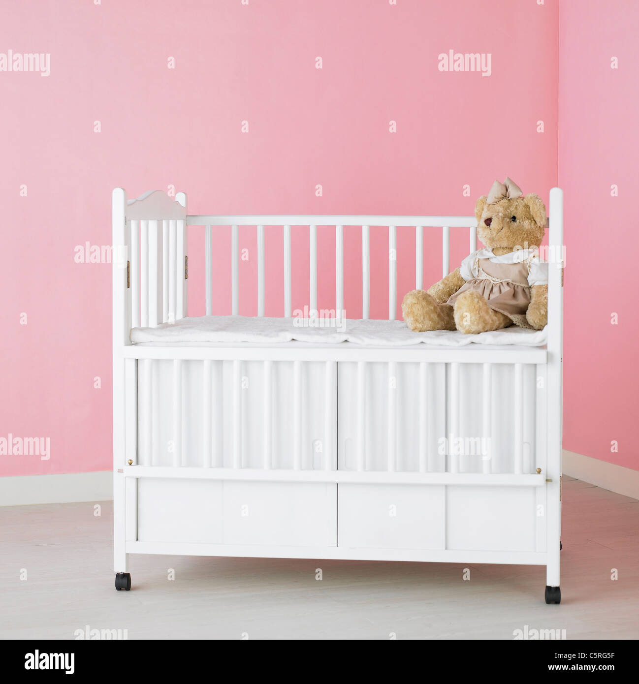 A white cradle and teddy bear Stock Photo - Alamy