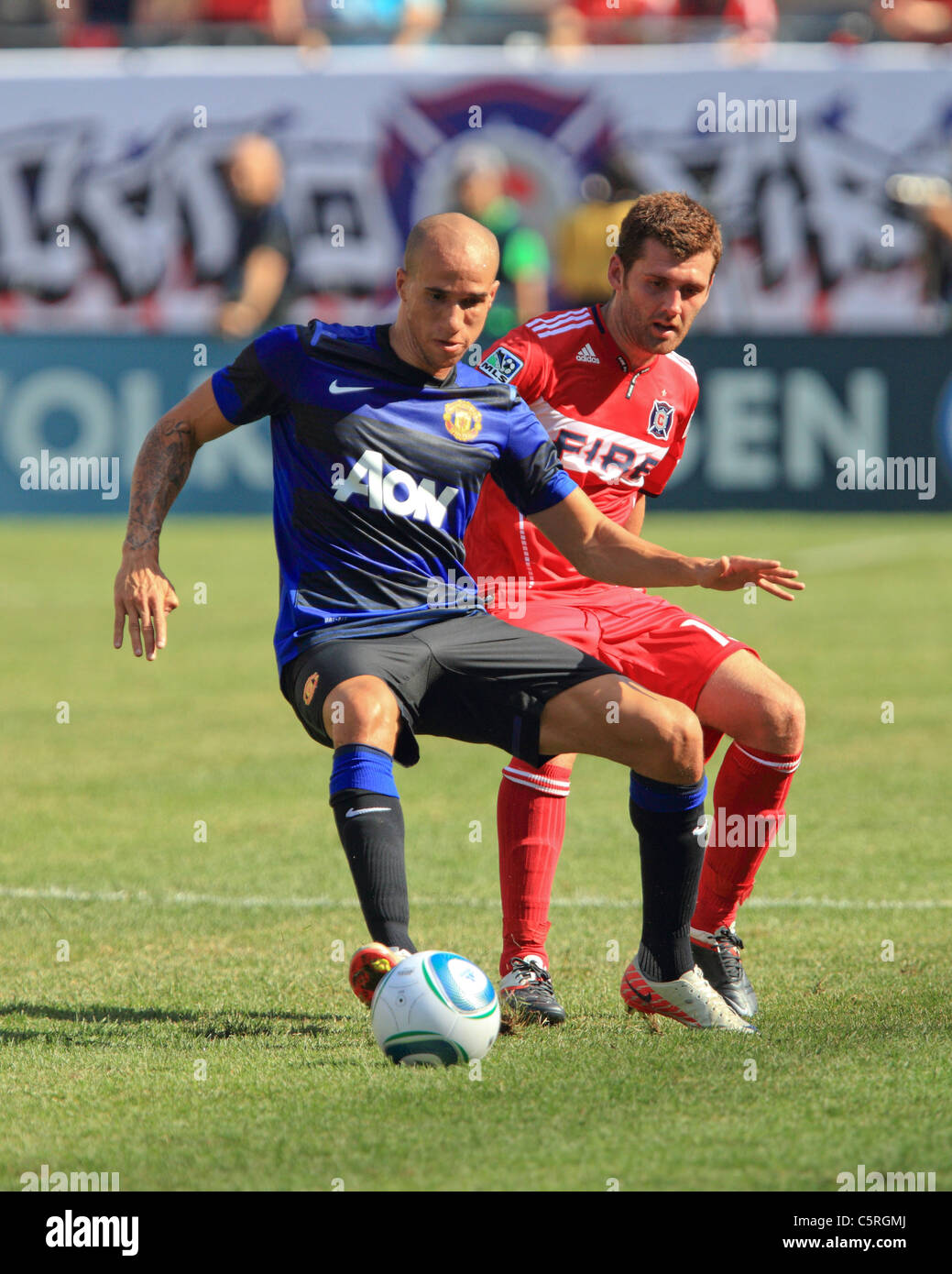 Manchester United winger, Gabriel Obertan (L), battles for the ball, vs ...