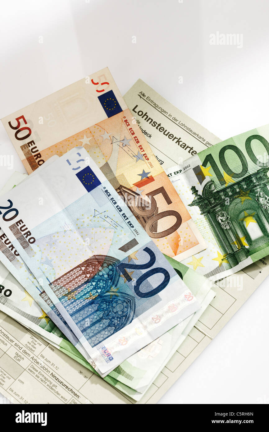 Tax card, Euro coins and Euro bank notes in wage packet, elevated view ...