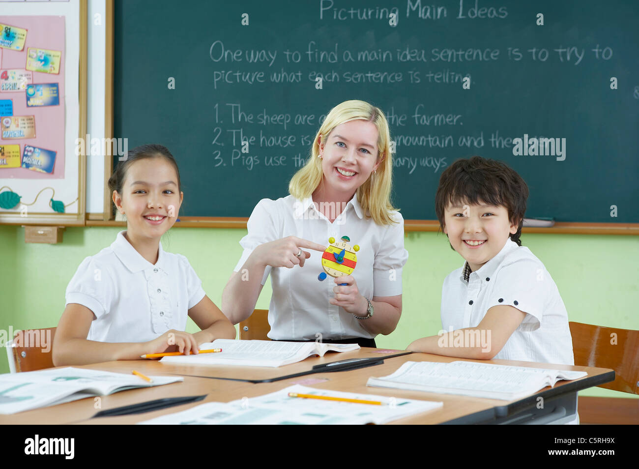 A teacher teaching students Stock Photo - Alamy