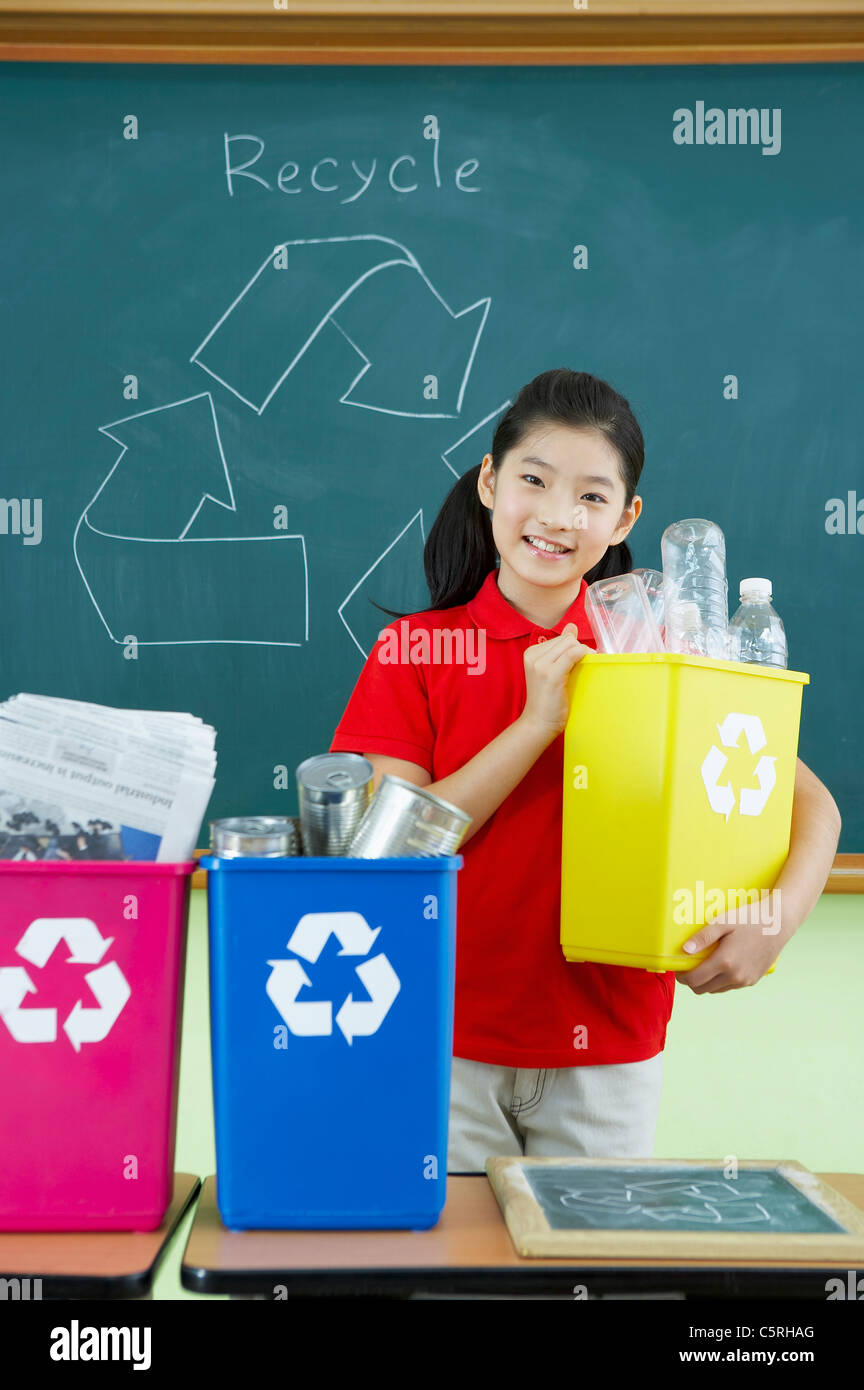 A girl holding recycle bin Stock Photo - Alamy