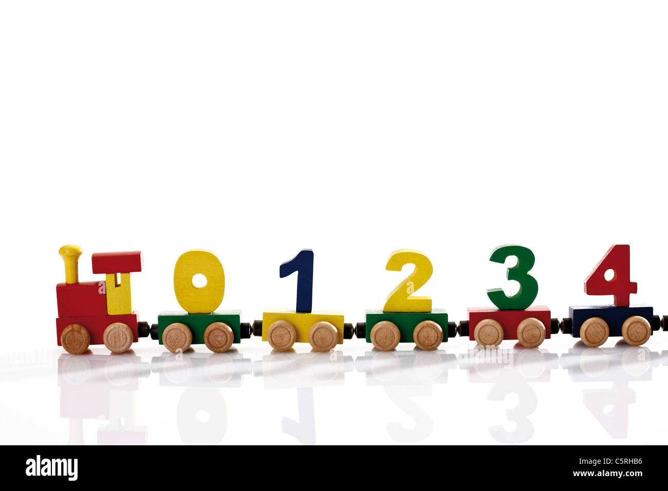 Colourful wooden toy train with figures Stock Photo - Alamy