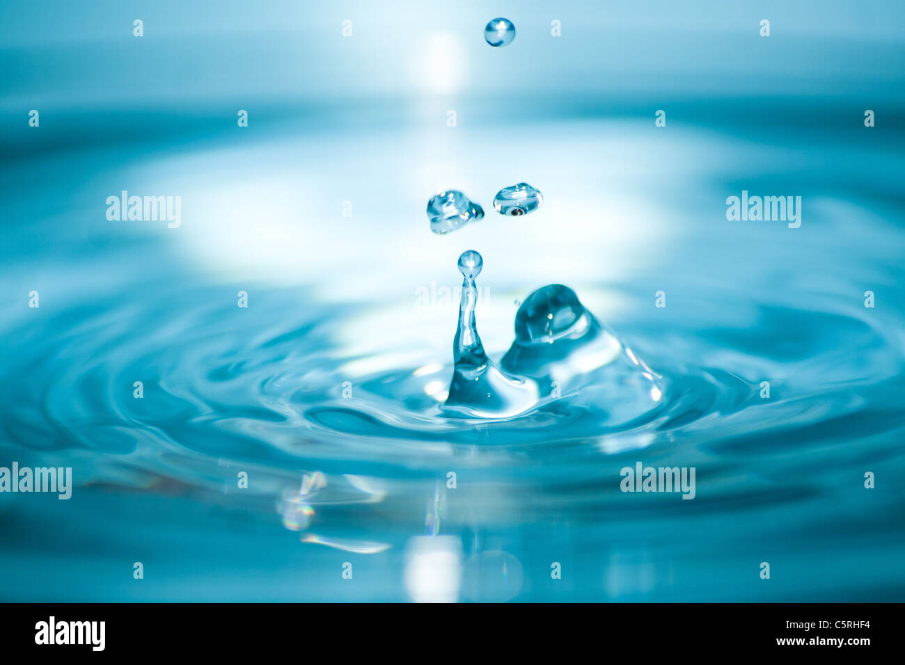 A splash of blue water, with ripples spreading out Stock Photo - Alamy