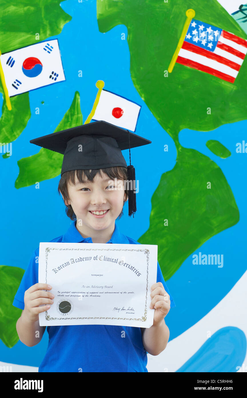 A boy holding a certificate Stock Photo - Alamy