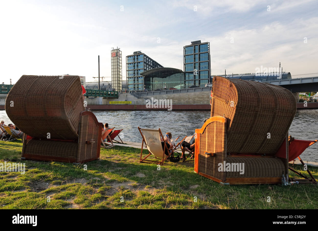 Beach with roofed wicker beach chairs on the Spree River, in front of ...