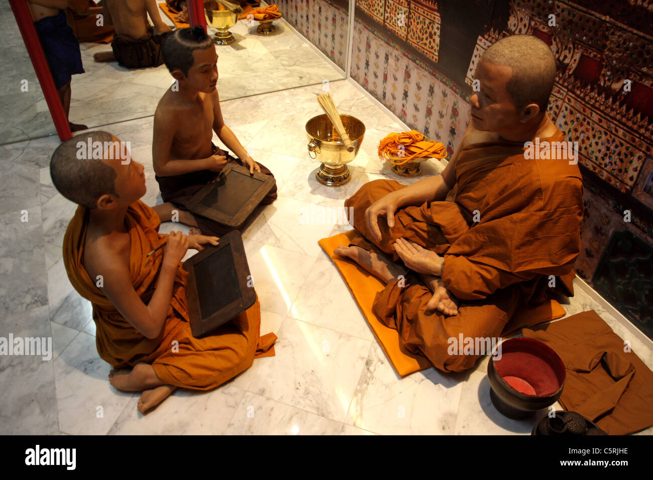 Wax models , Old Thai monk teaching students Stock Photo - Alamy