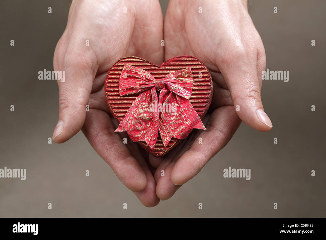 Holding a heart shaped box Stock Photo - Alamy