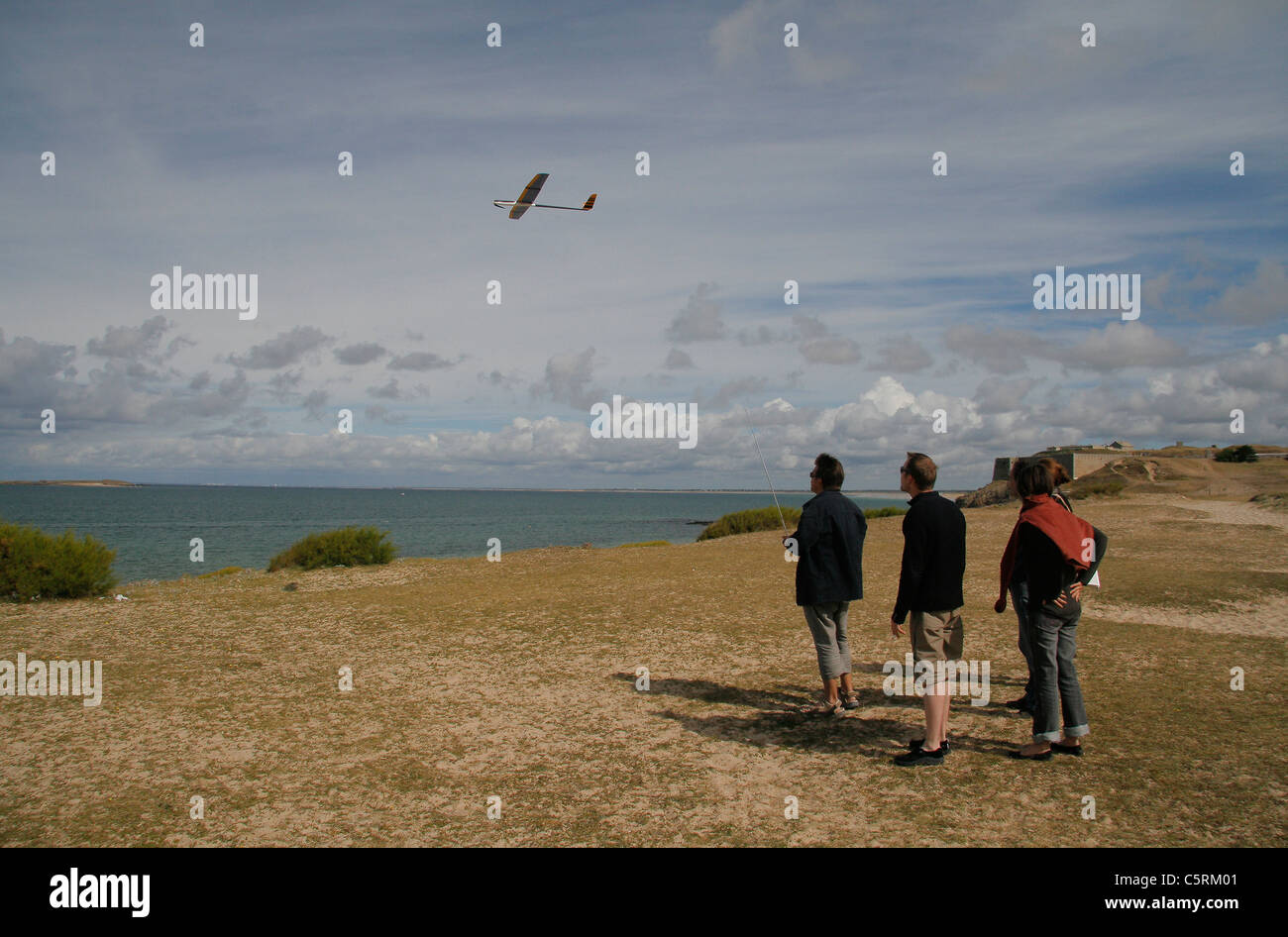 Radio-controlled glider (glider model) currently hovering over a dune ...