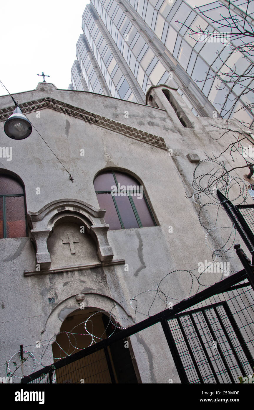 A church with barbed wire and a high rise building, Istanbul, Turkey ...
