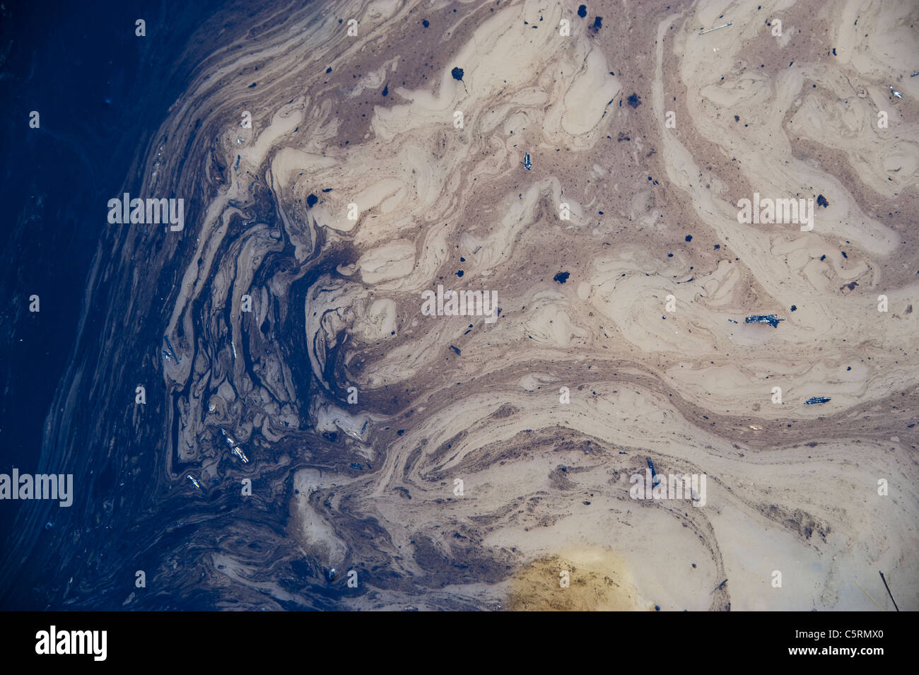 A close up image of used oil floating on the water Stock Photo - Alamy