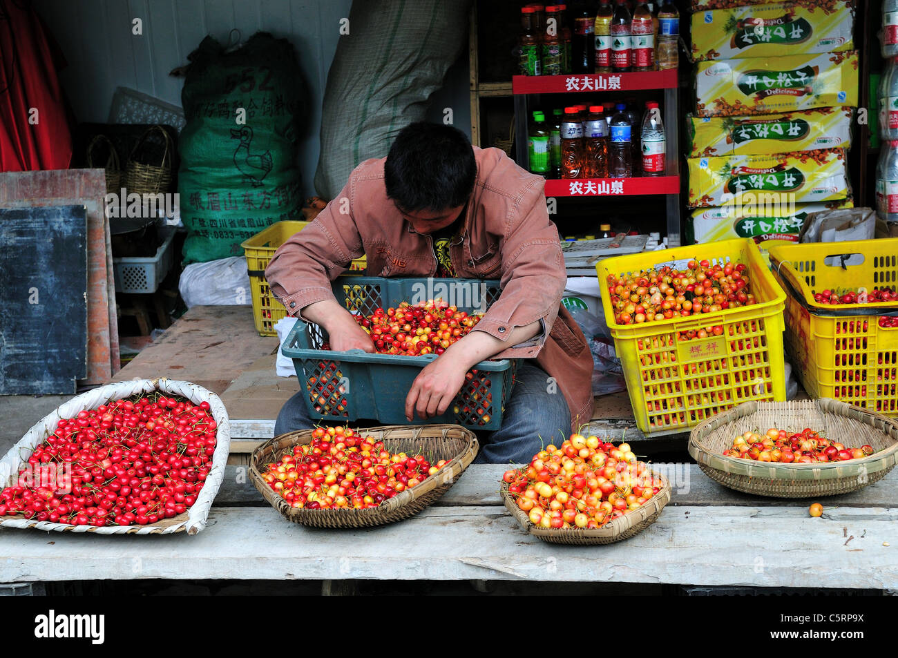 A man selling cherries at a stand. Sichuan, China Stock Photo - Alamy