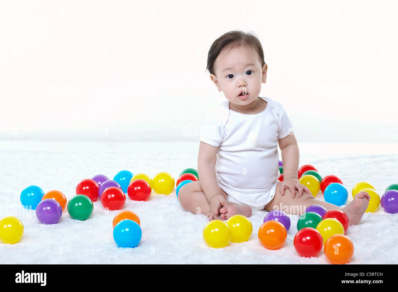 A baby with balls Stock Photo - Alamy