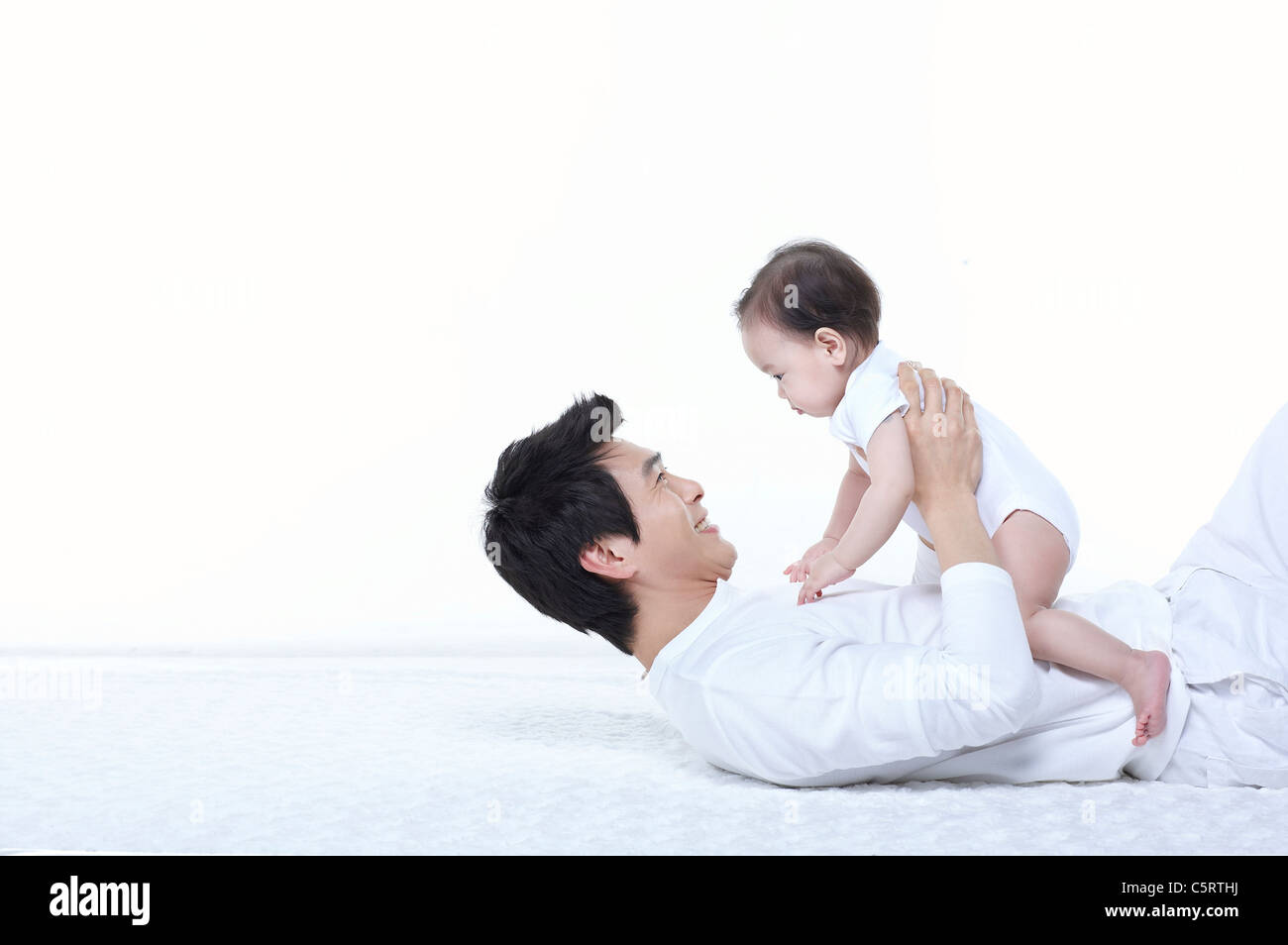 A father holding up his baby Stock Photo - Alamy
