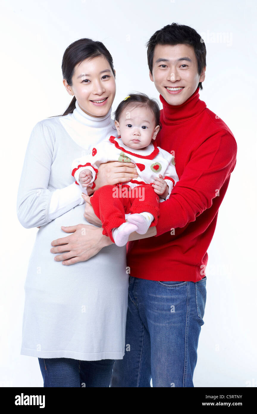 Parents hugging their baby Stock Photo - Alamy