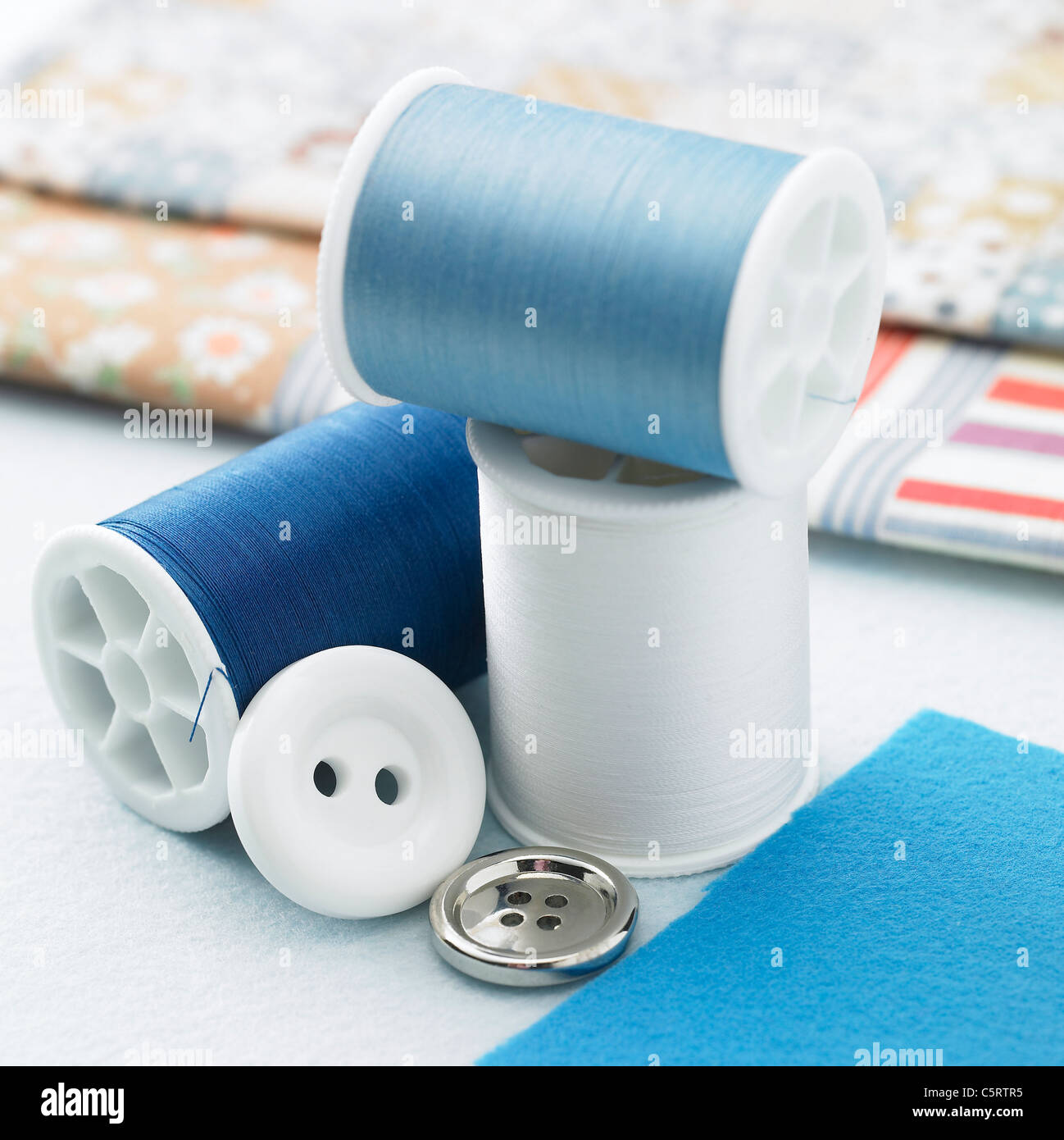 Thread, button and cloth Stock Photo - Alamy