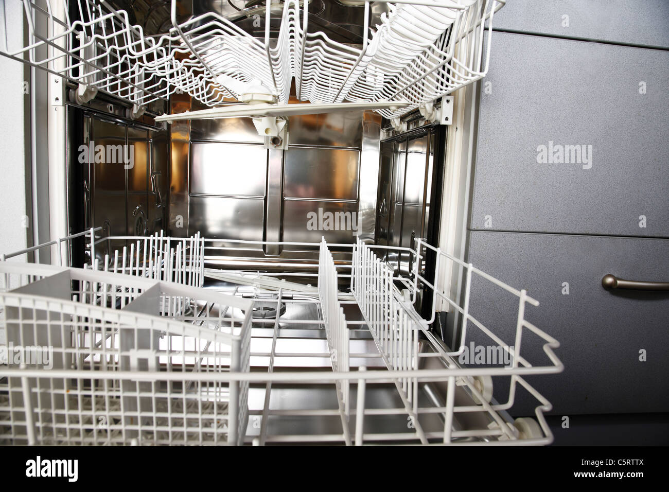 Empty dishwasher, close-up Stock Photo - Alamy