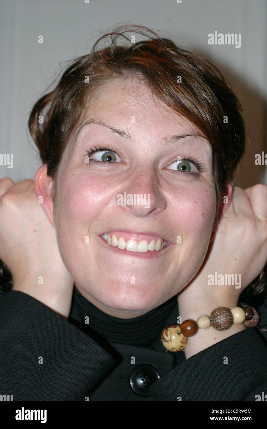 female pulling faces at the camera Stock Photo - Alamy