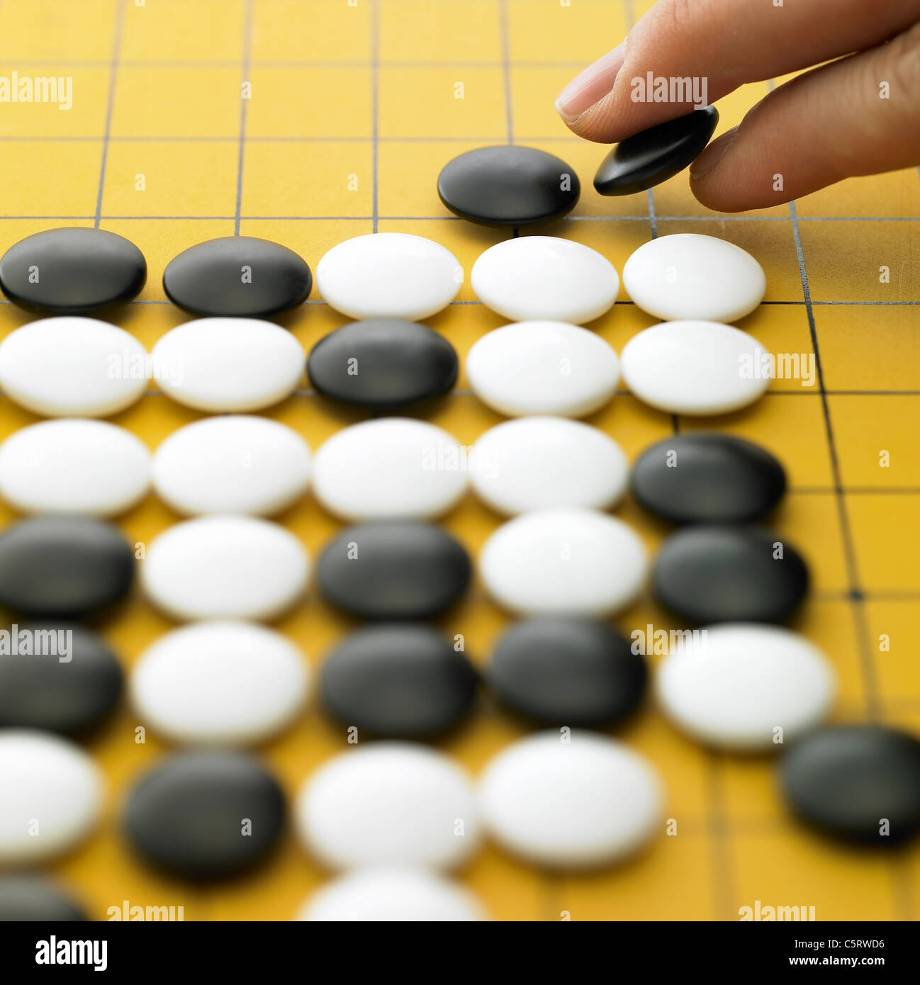 A hand on go board Stock Photo - Alamy