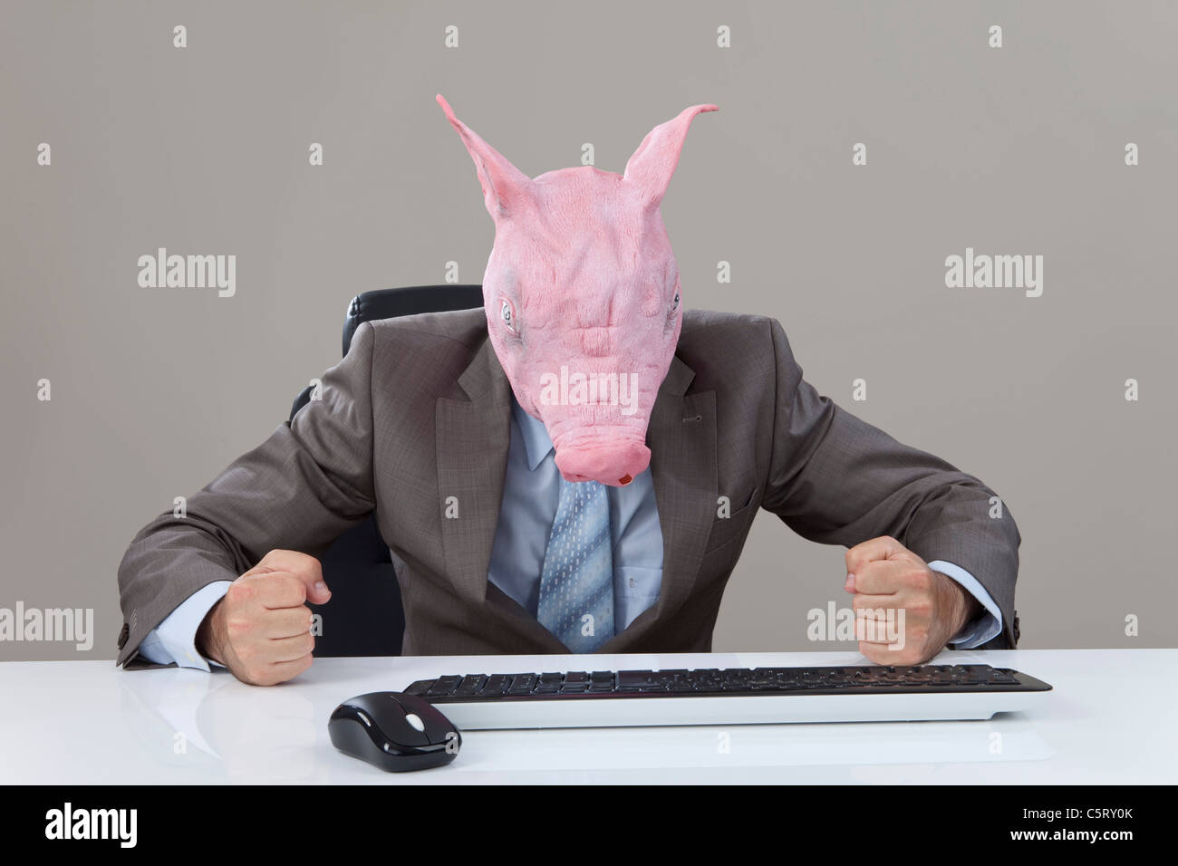 Close up of businessman with pigs head hitting table in office against ...