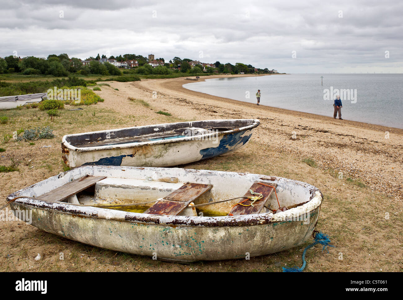 Old rowing boats beached on the foreshore of Mersea Island in Essex ...