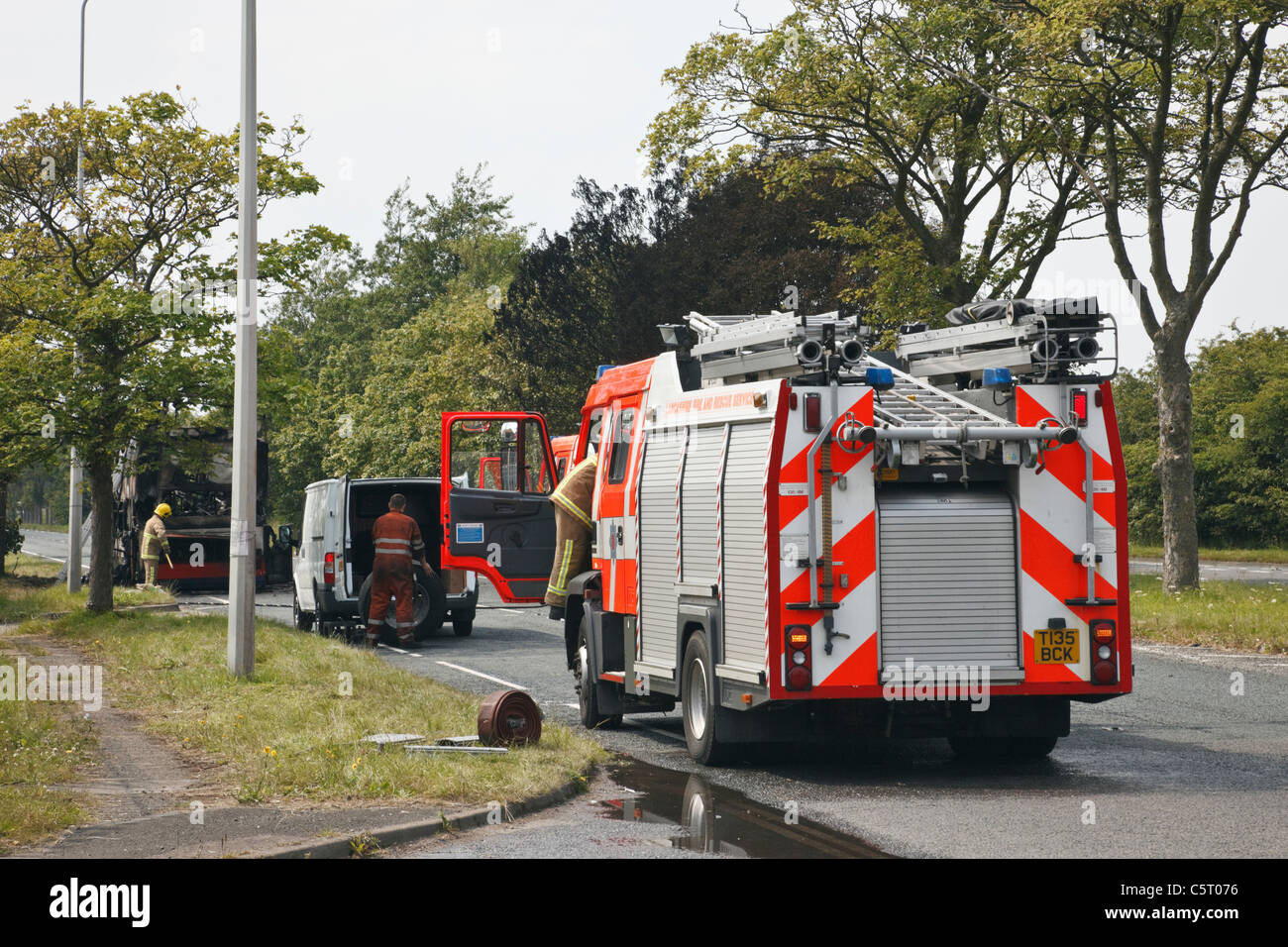 Lancashire, England, UK. Fire engine and crew attending to an incident ...