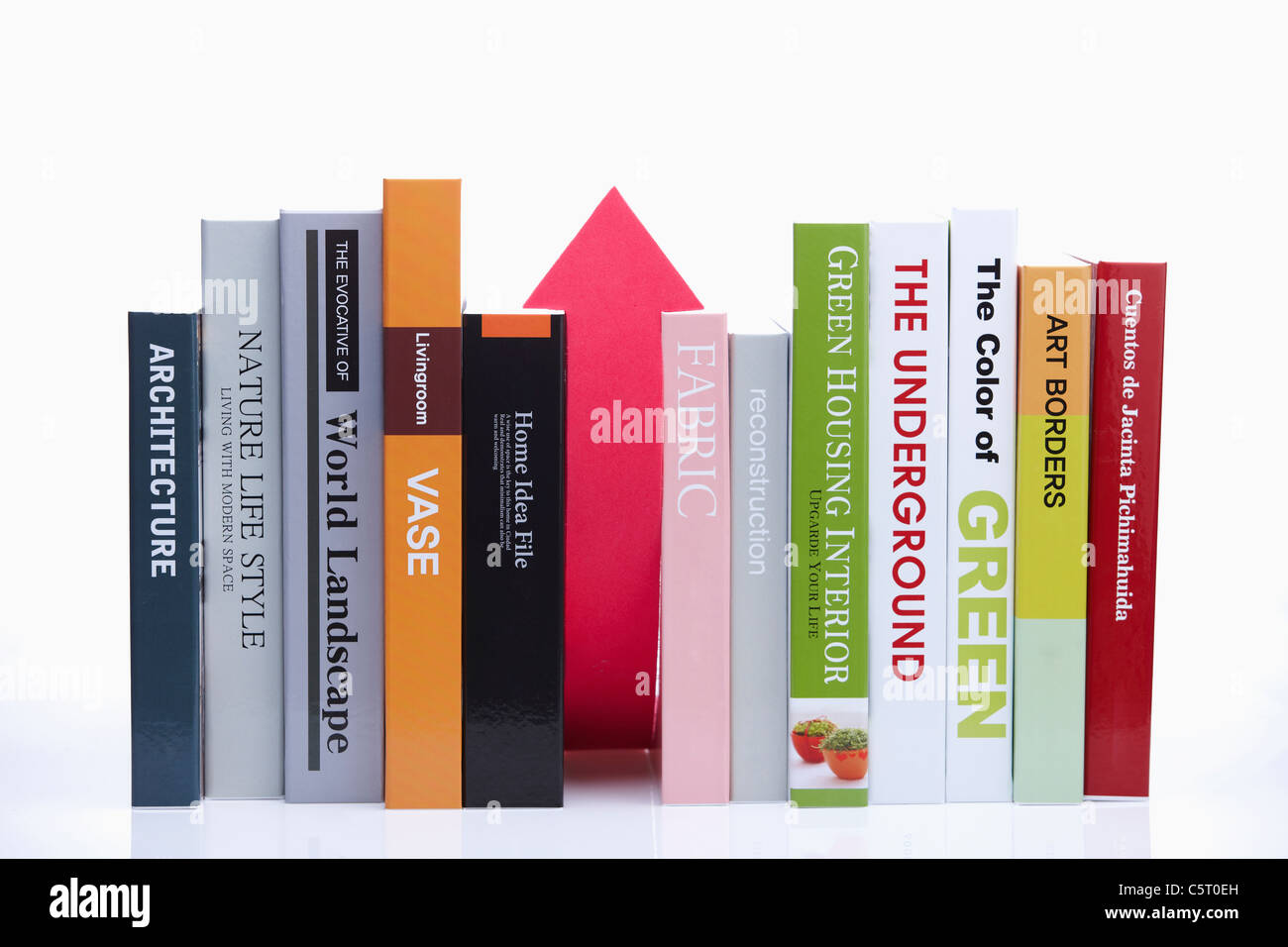 arrow sign is behind the books Stock Photo - Alamy