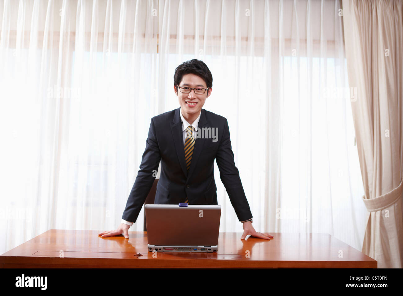 man standing in front of the desk Stock Photo - Alamy