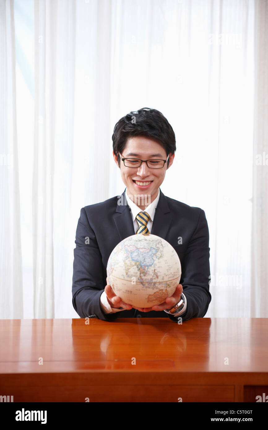 man holding globe Stock Photo - Alamy
