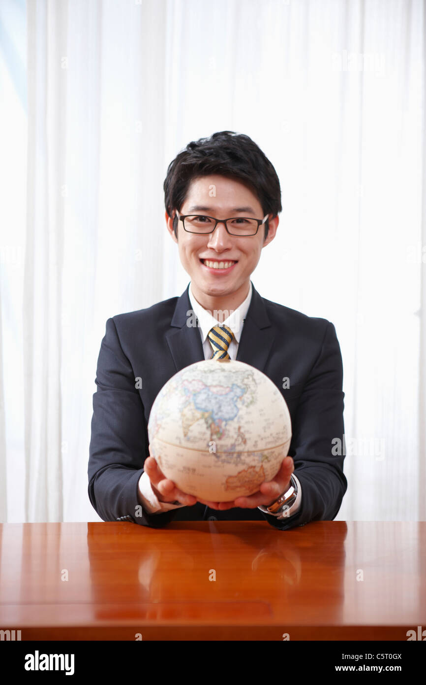 man holding globe Stock Photo - Alamy