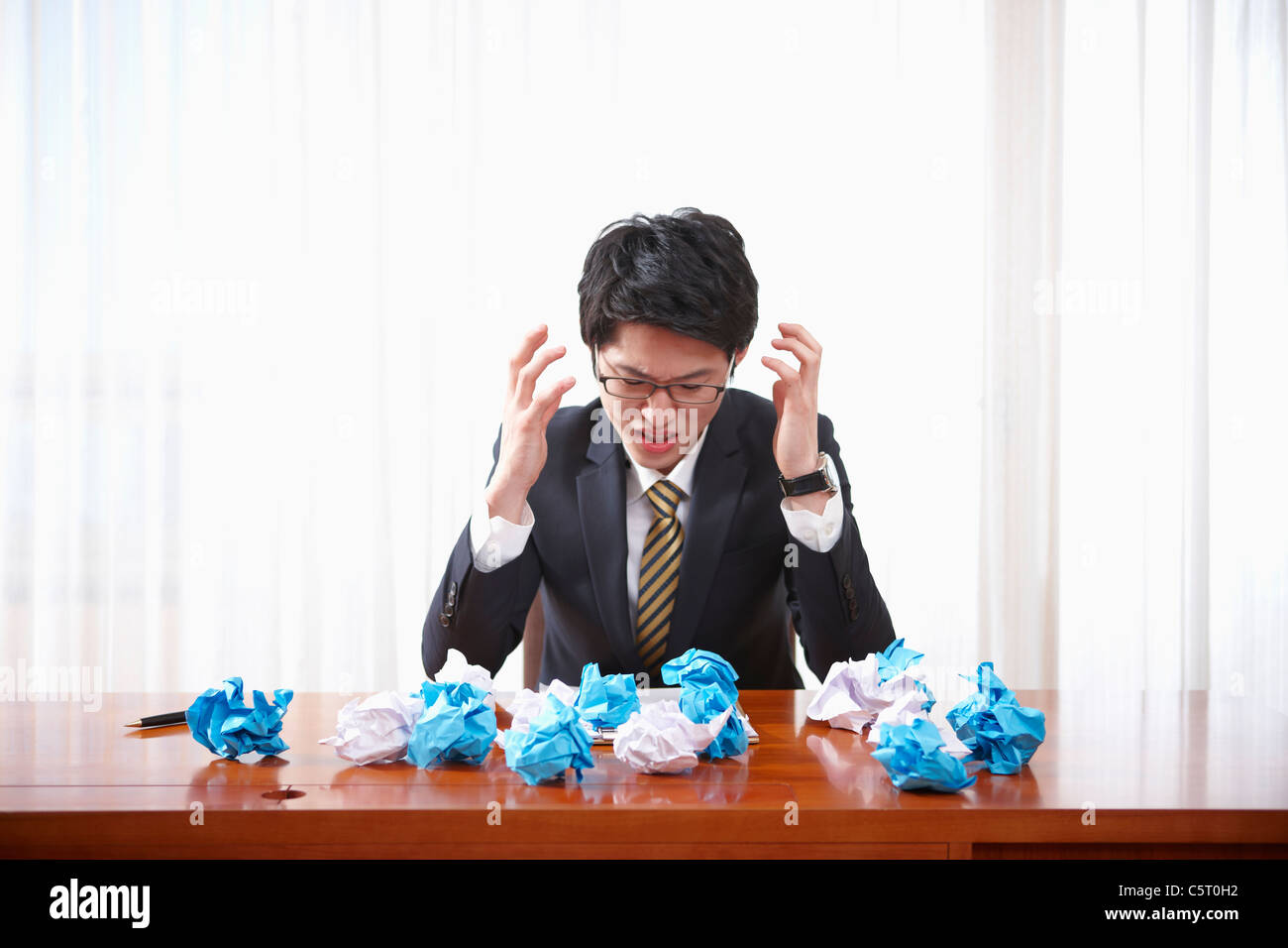 man is frowning with scraps of paper Stock Photo - Alamy