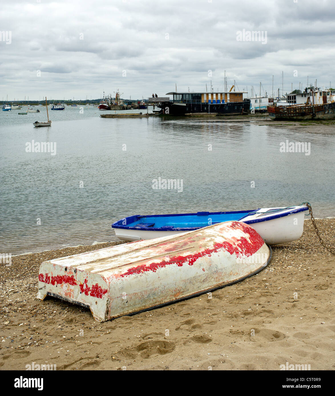Rowing boats beached on the foreshore of Mersea Island in Essex Stock ...