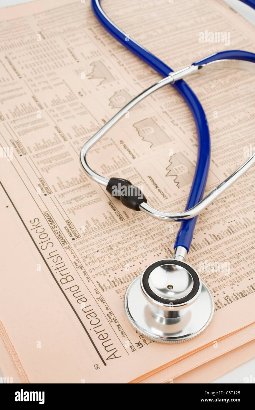 Stethoscope on stock reports, elevated view Stock Photo - Alamy