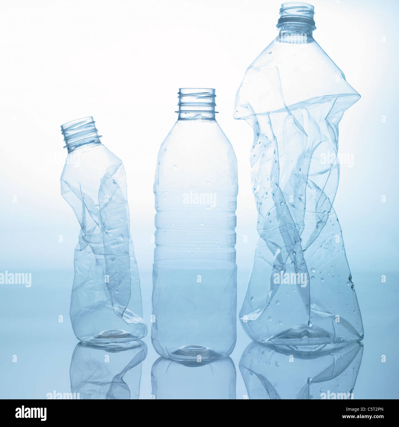 Crumpled plastic bottles and normal plastic bottle Stock Photo - Alamy