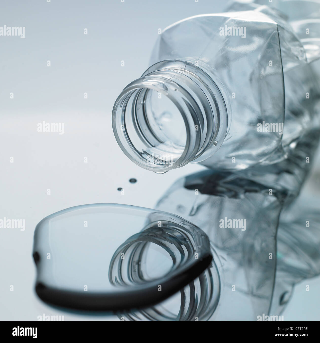 Crumpled plastic bottle with water Stock Photo - Alamy