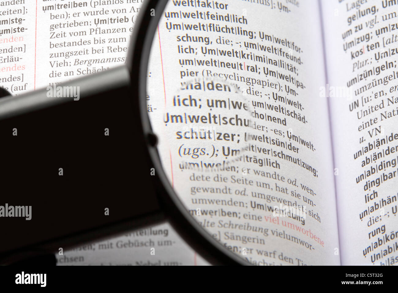 Magnifying glass on encyclopedia, close-up Stock Photo - Alamy