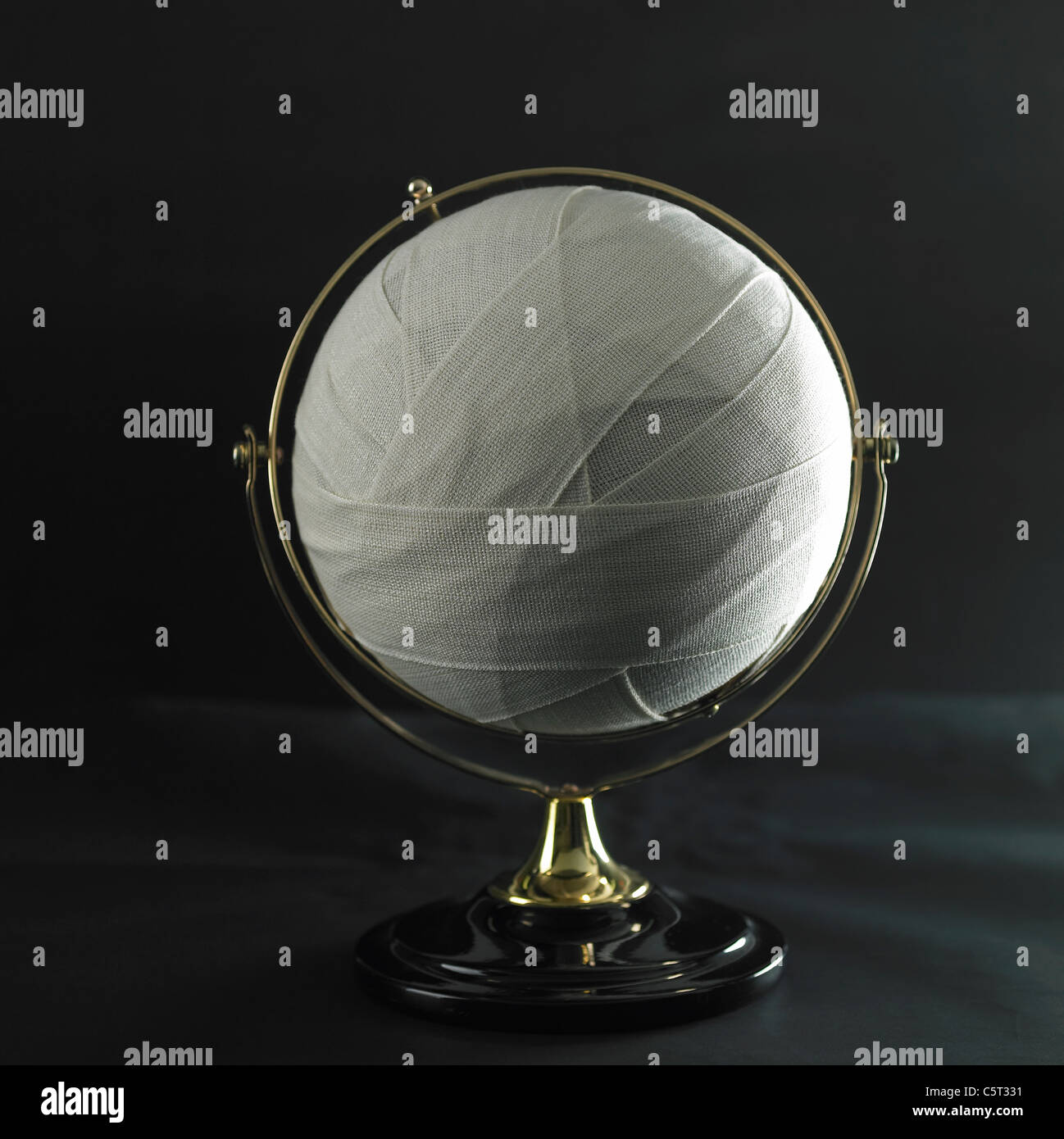 A globe with bandage around Stock Photo - Alamy