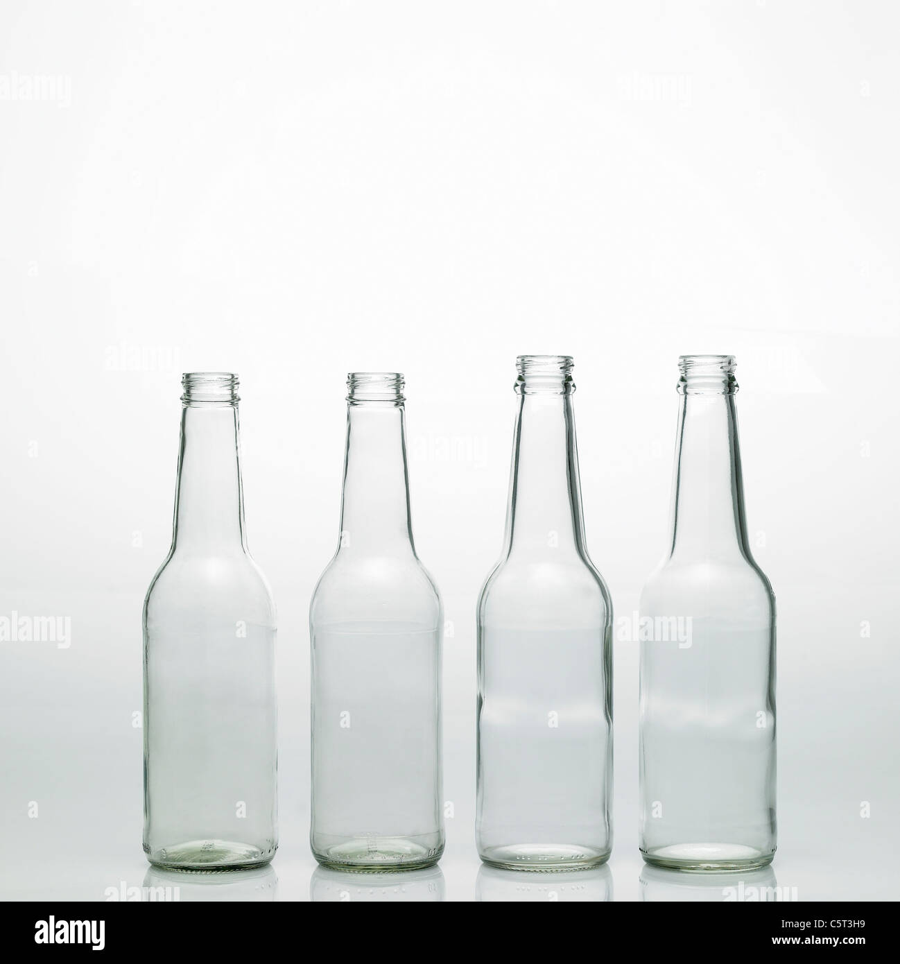 Glass bottles in a row Stock Photo - Alamy