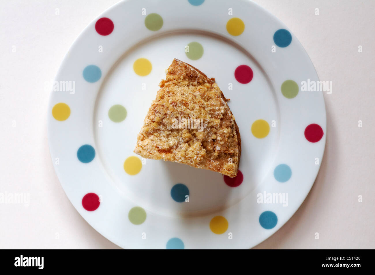 piece of Tesco Finest Madagascan Vanilla & Apple Crumble Cake on spotty ...