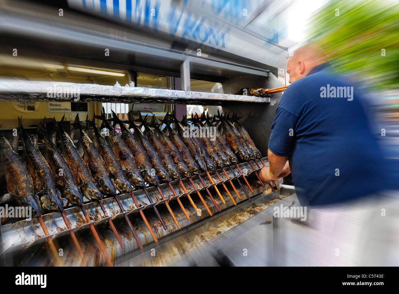 Germany, Munich, Auer Dult, Skewered fish on grill Stock Photo - Alamy