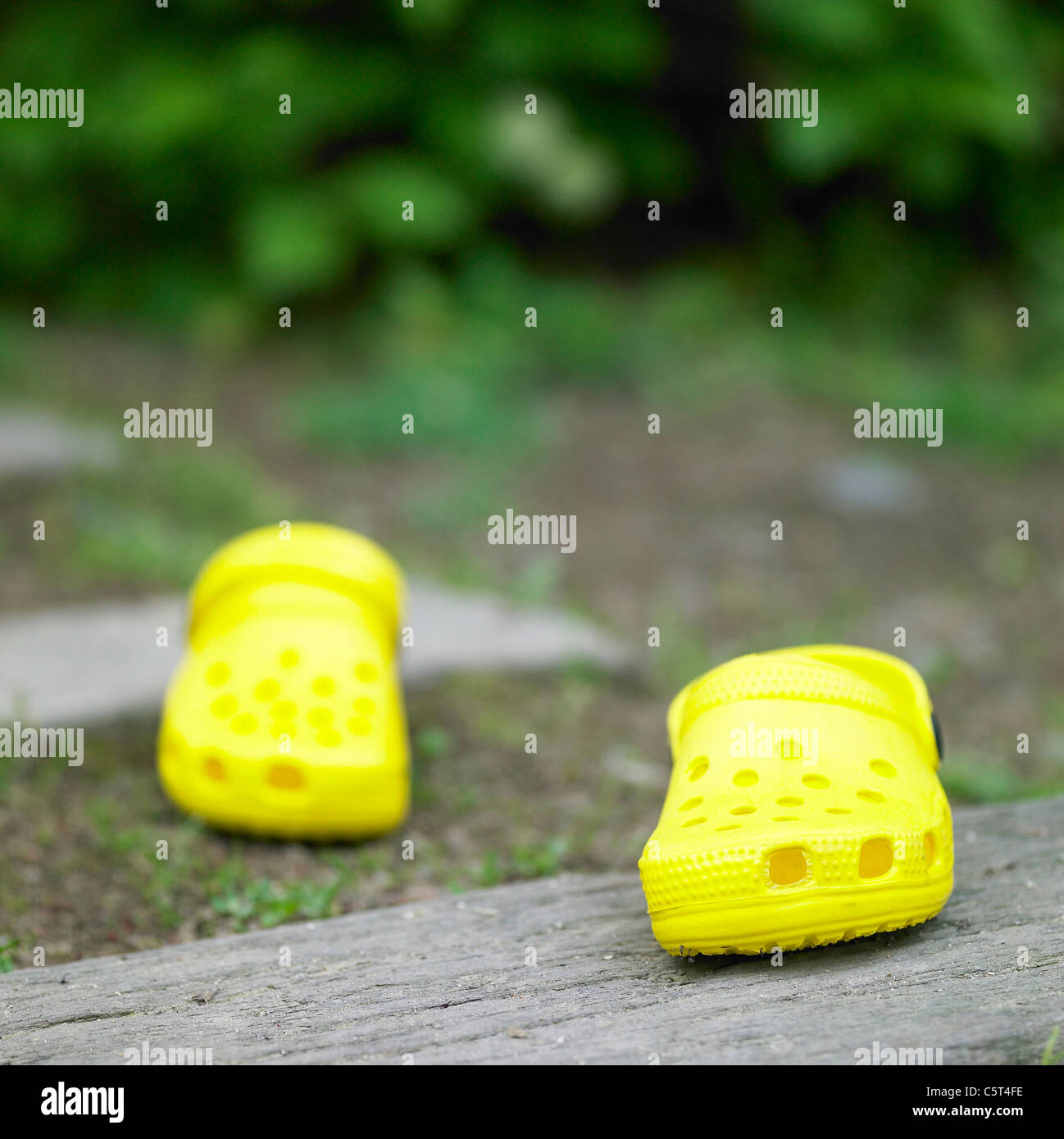 Yellow shoes on the ground Stock Photo - Alamy